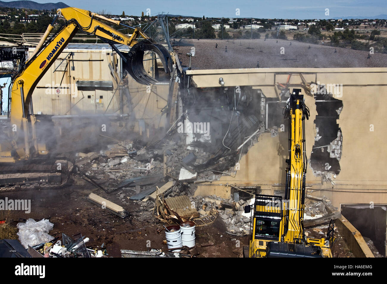 This image depicts a controlled demolition of an old building ...