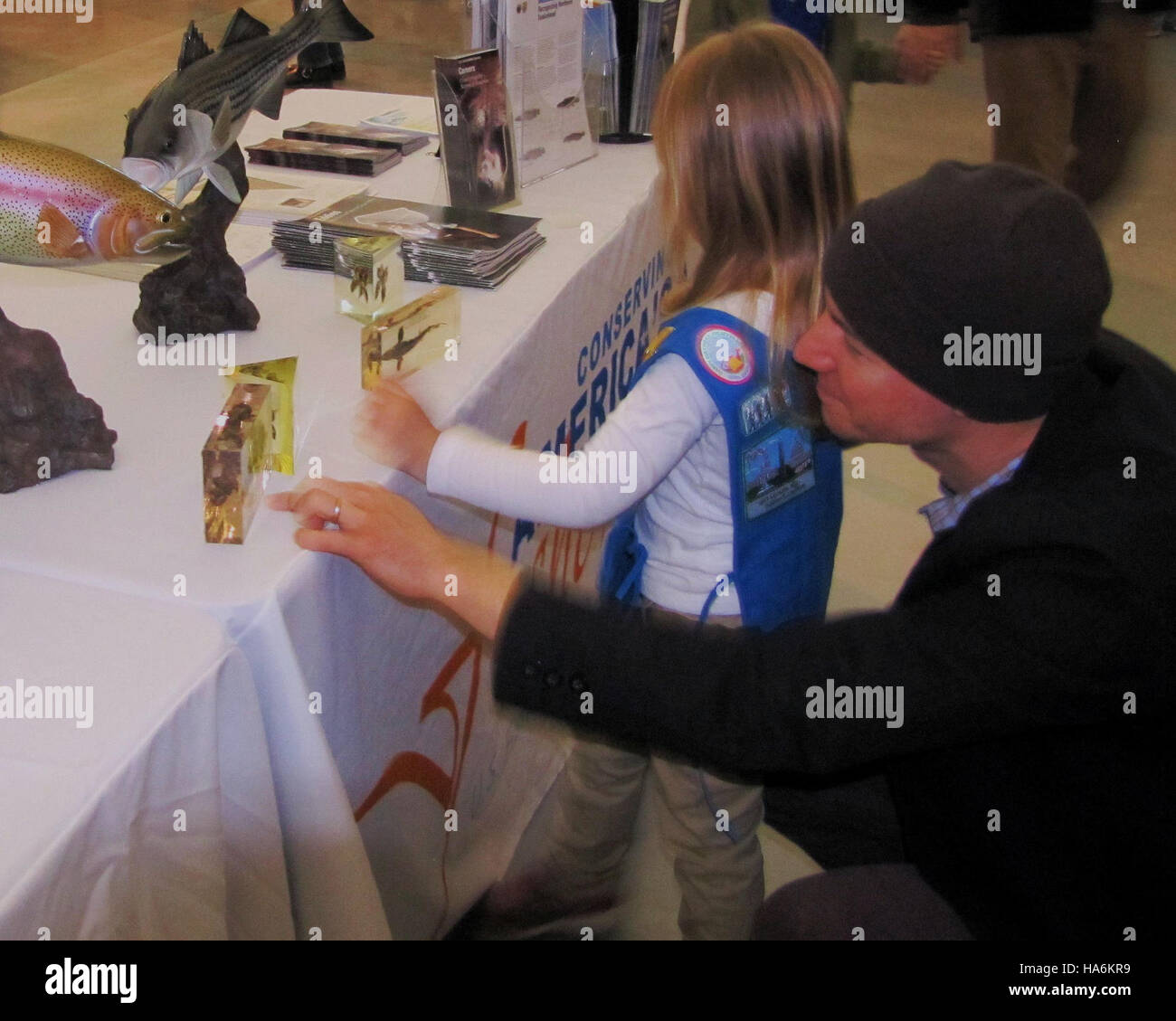 A father and son observe fish species at the 'Conserving America's ...