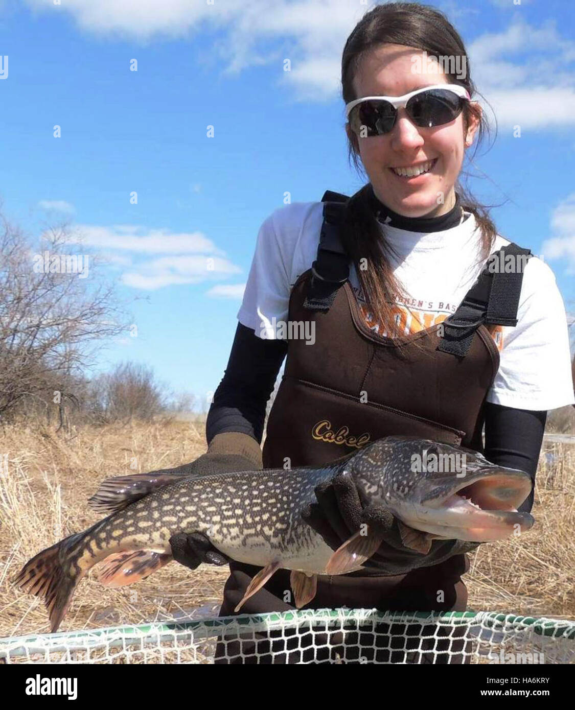 Rachel Van Dam holds a Northern Pike caught in Duck Creek, photographed ...