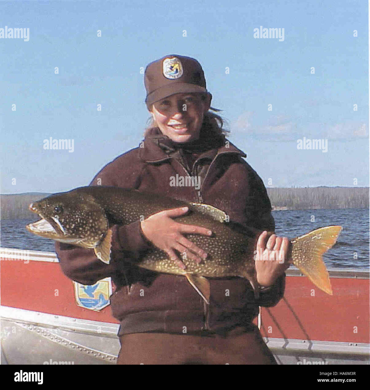 Bonnie, a fishery expert, holds a Lewis Lake trout in Yellowstone Park ...