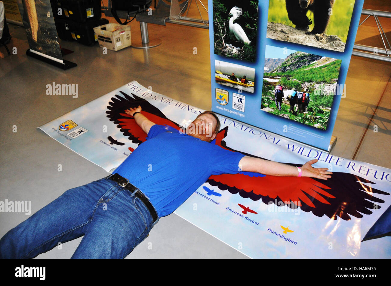 Christopher Deets demonstrates the impressive wingspan of a bird at a ...