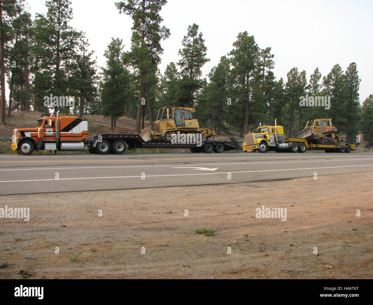 This image shows heavy equipment being transported to a fire line ...