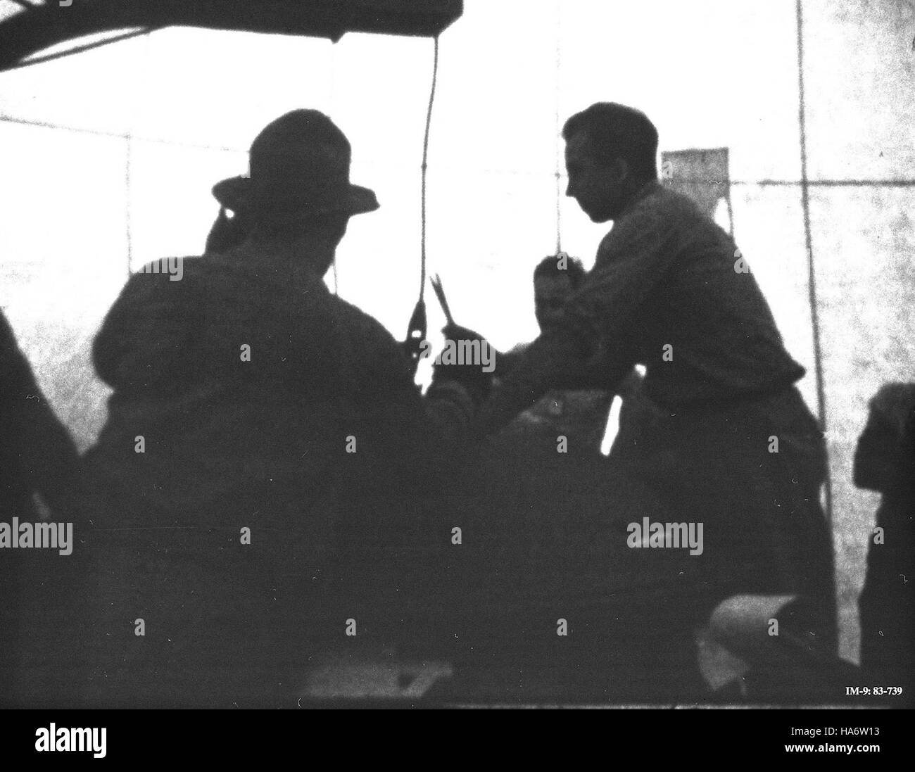 J. Robert Oppenheimer oversees the final assembly of the Gadget, the ...