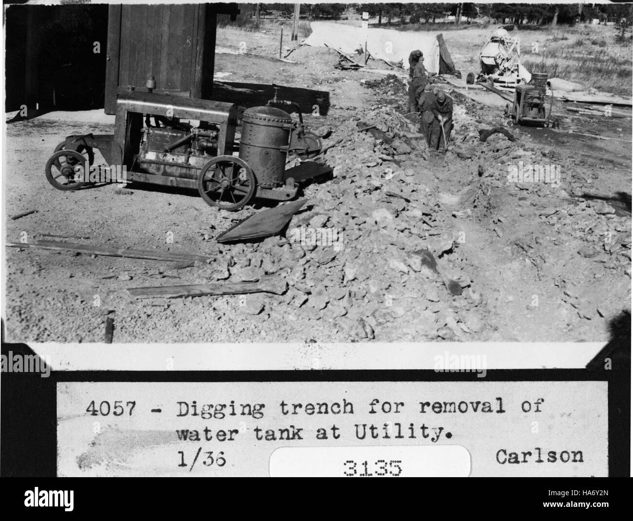 This historical photo shows workers digging a trench to remove a water ...
