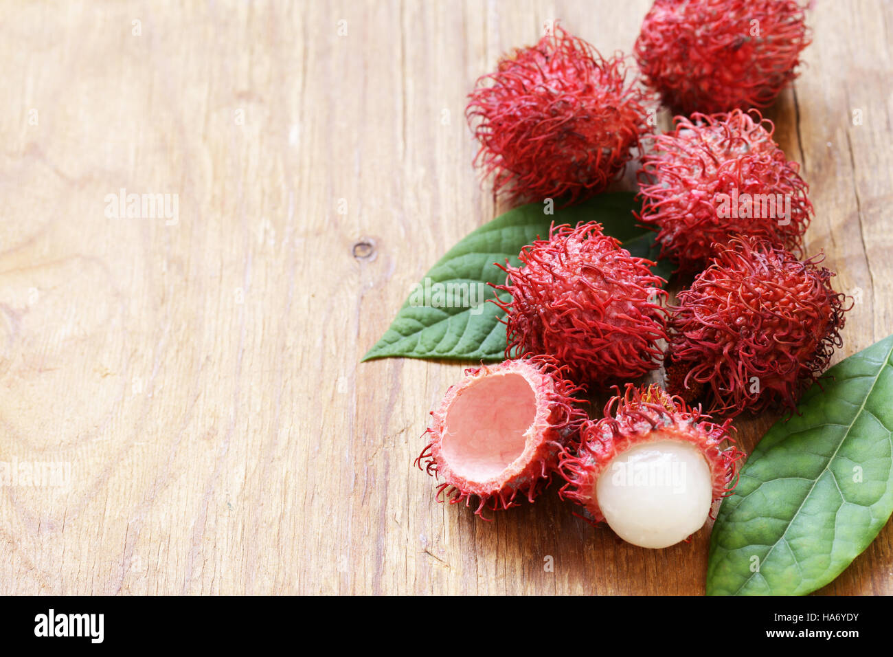 Natural organic lychee fruit (rambutan) on a wooden table Stock Photo ...