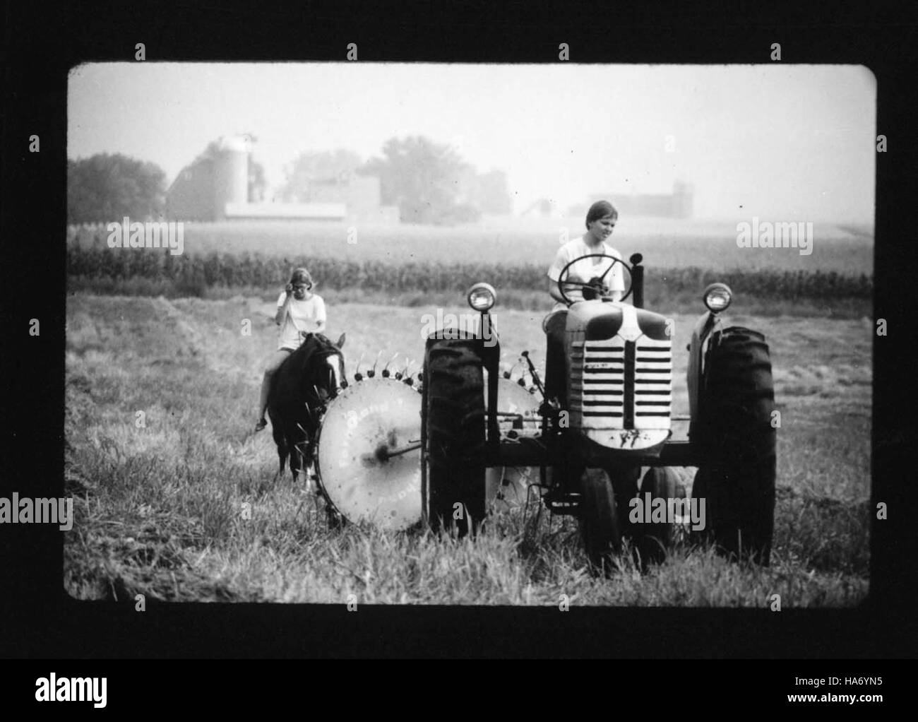 A historical image depicting women working on a tractor, highlighting ...