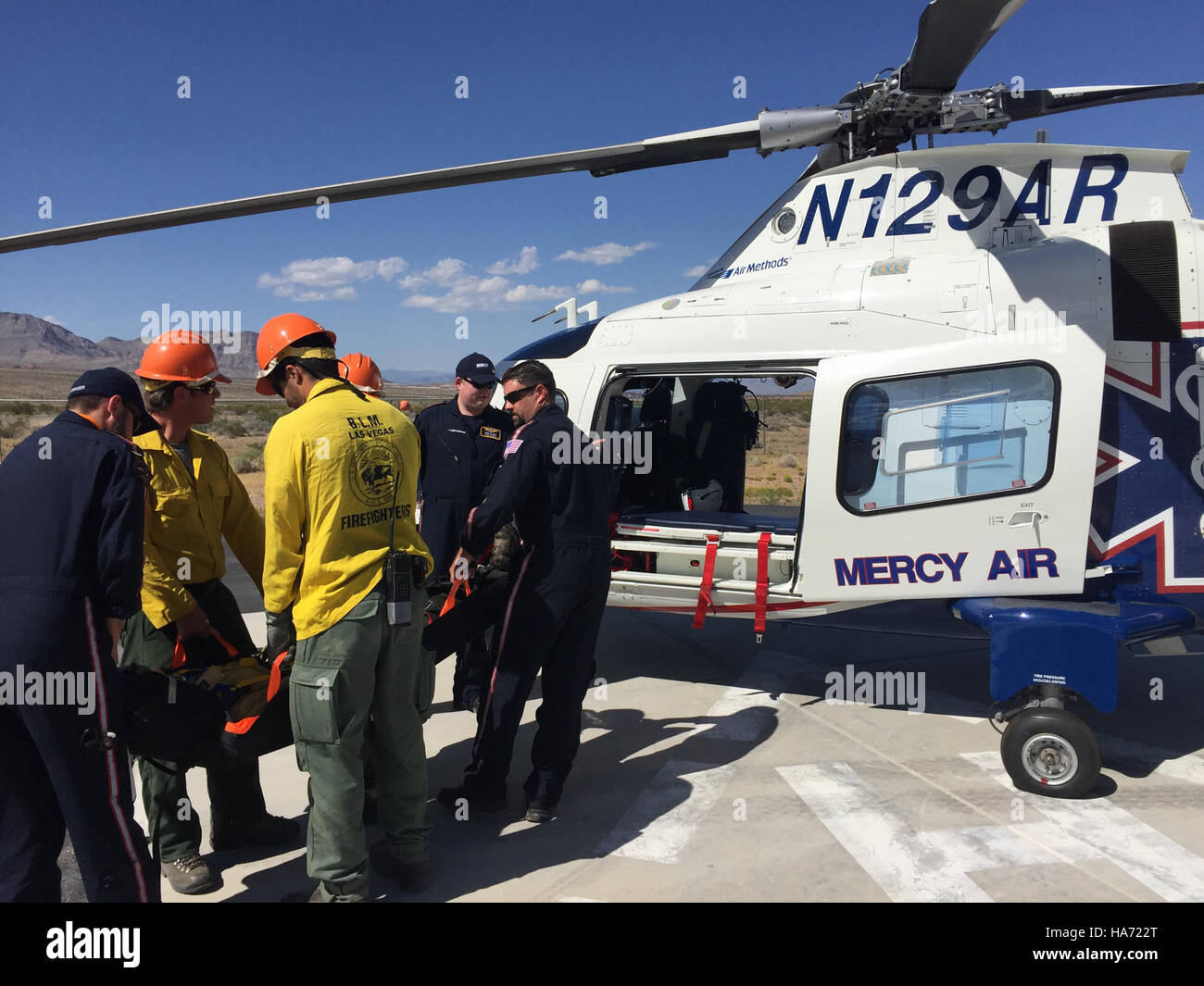 A Mercy helicopter is shown loading a patient during an emergency ...