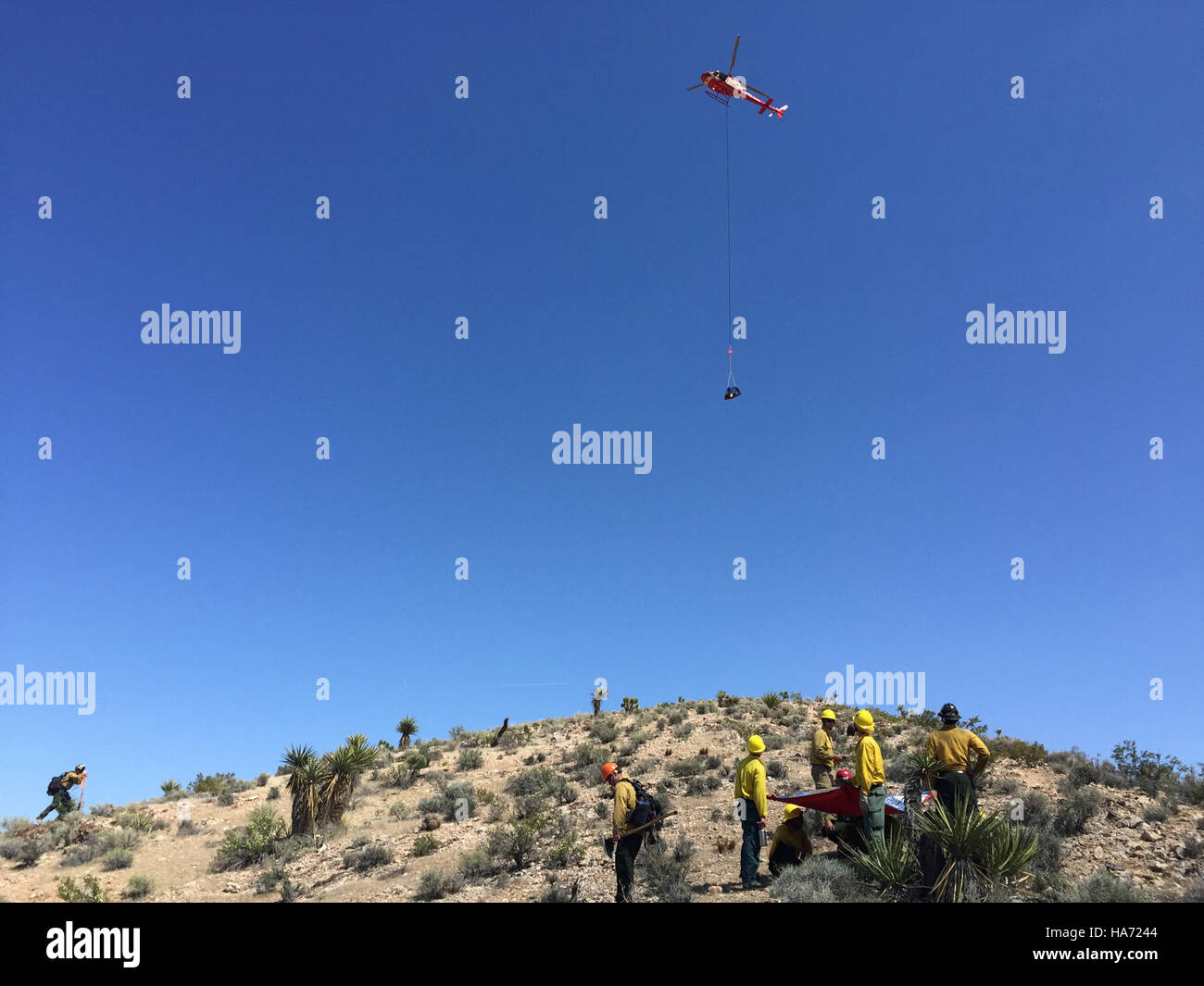 This image shows a helicopter being guided to land, likely for a ...