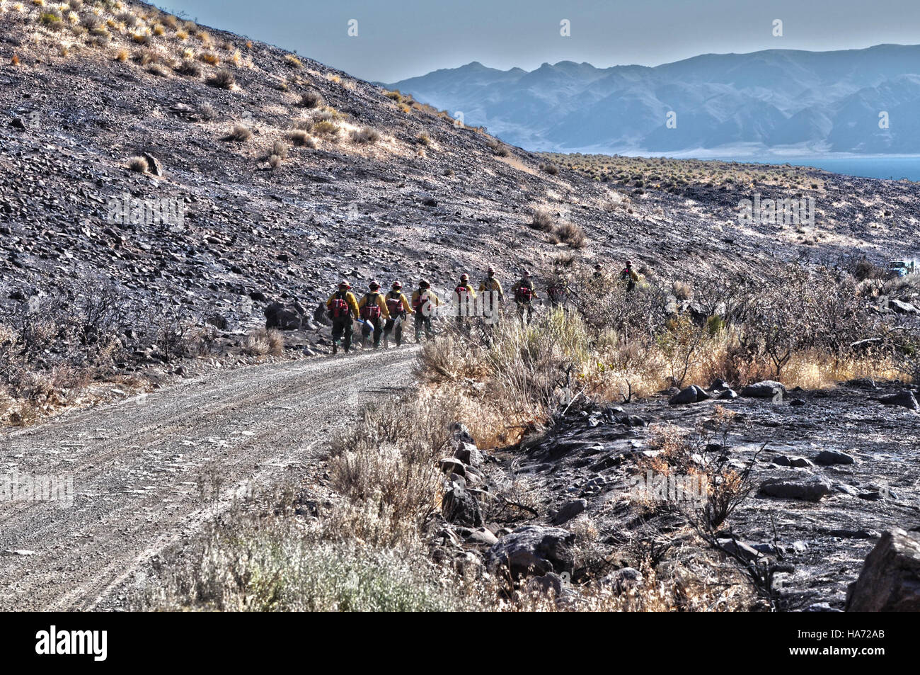 Fire management teams near Big Canyon work to mop up after a wildfire ...