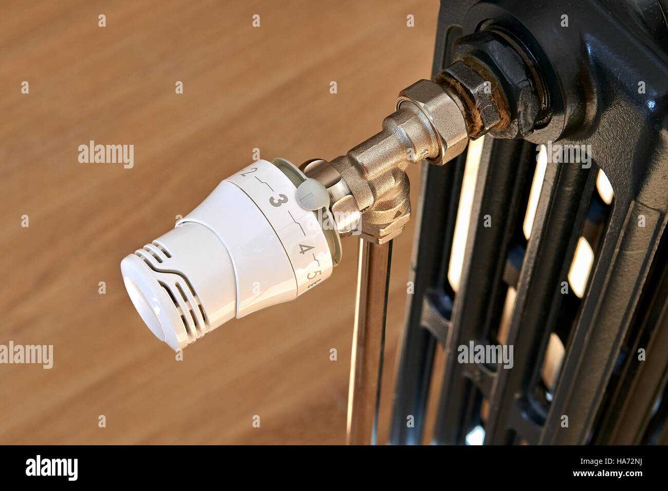 New valve on a old radiator in domestic room Stock Photo - Alamy