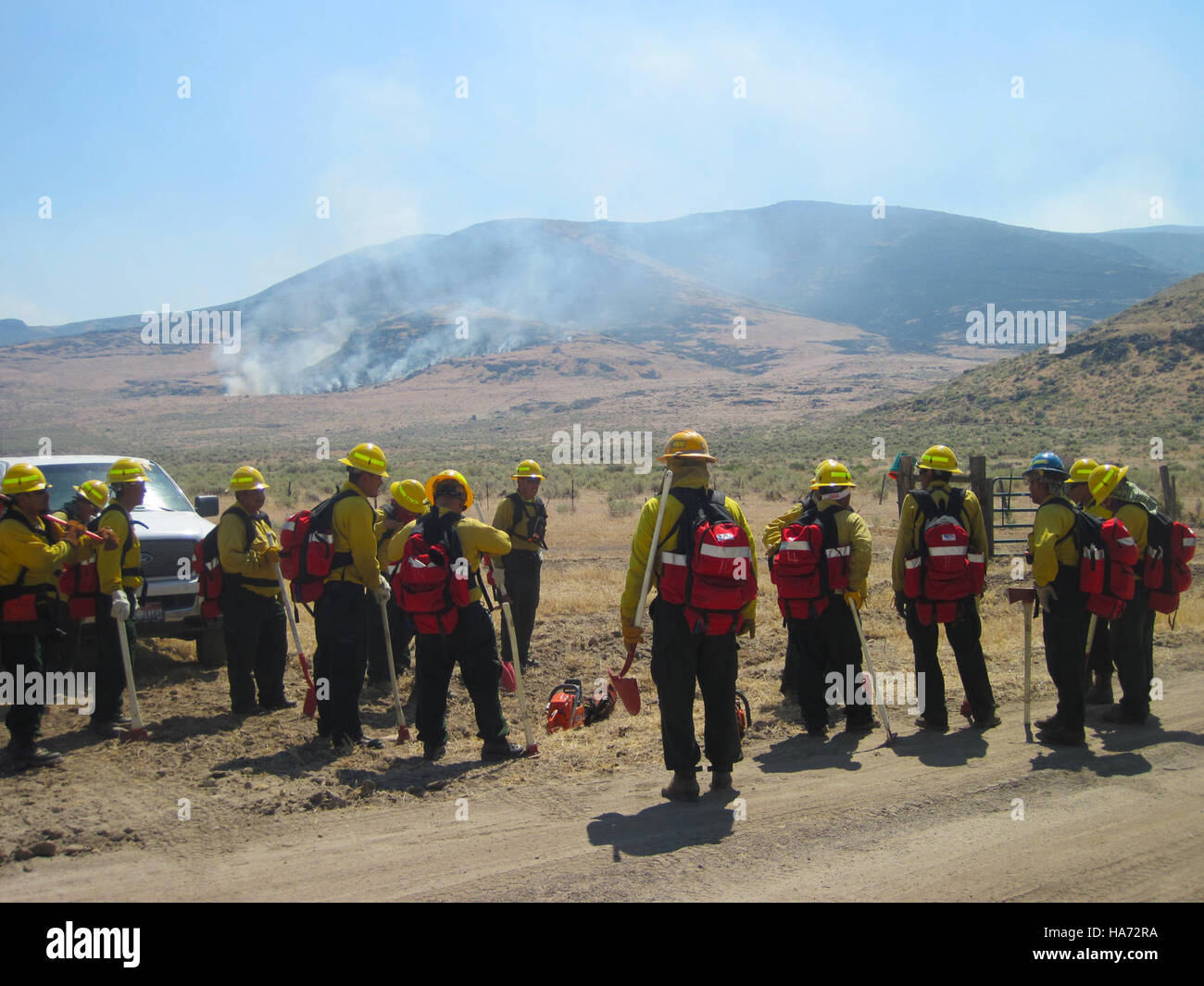 Fire crews in Nevada participate in a briefing before heading out to a ...