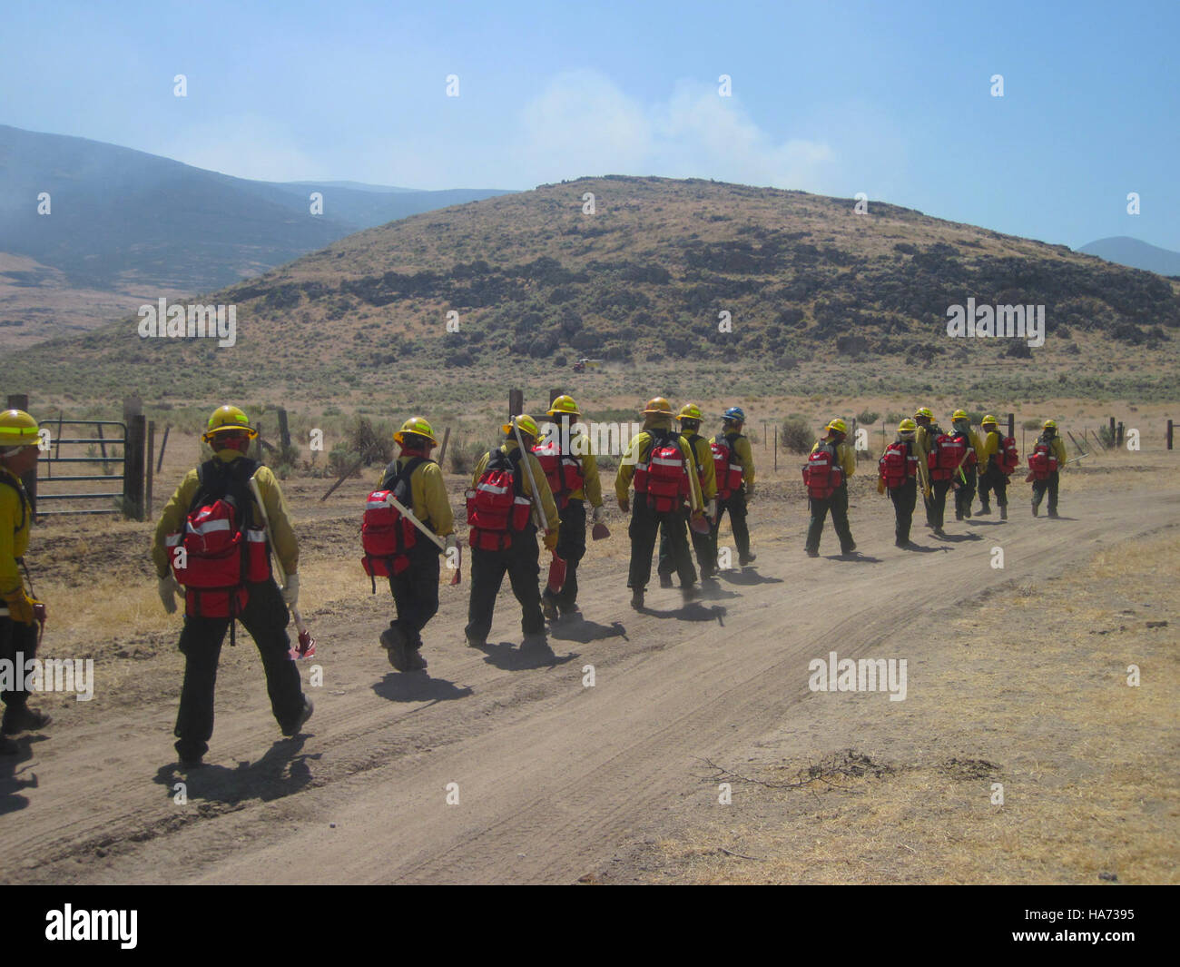 This image captures firefighters hiking out to the fire line during a ...