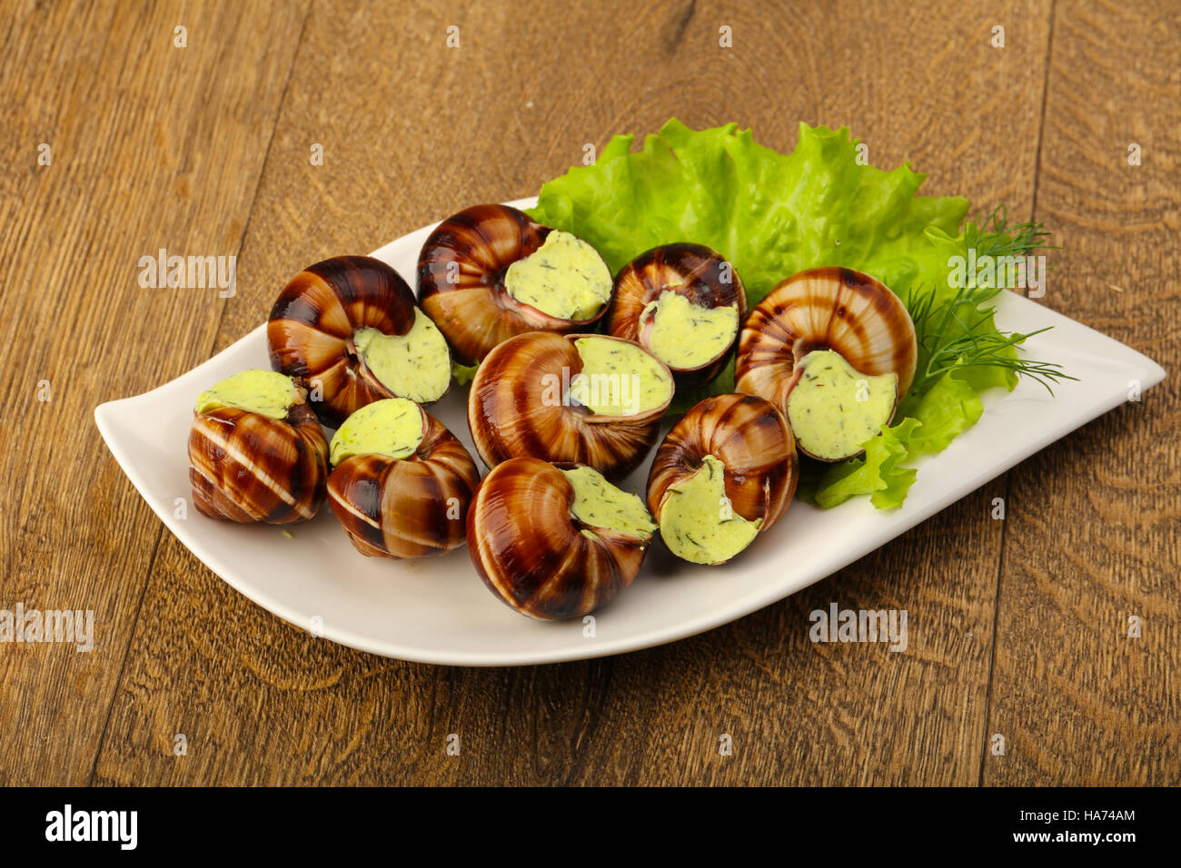 Escargot with cheese cream on salad leaves Stock Photo - Alamy