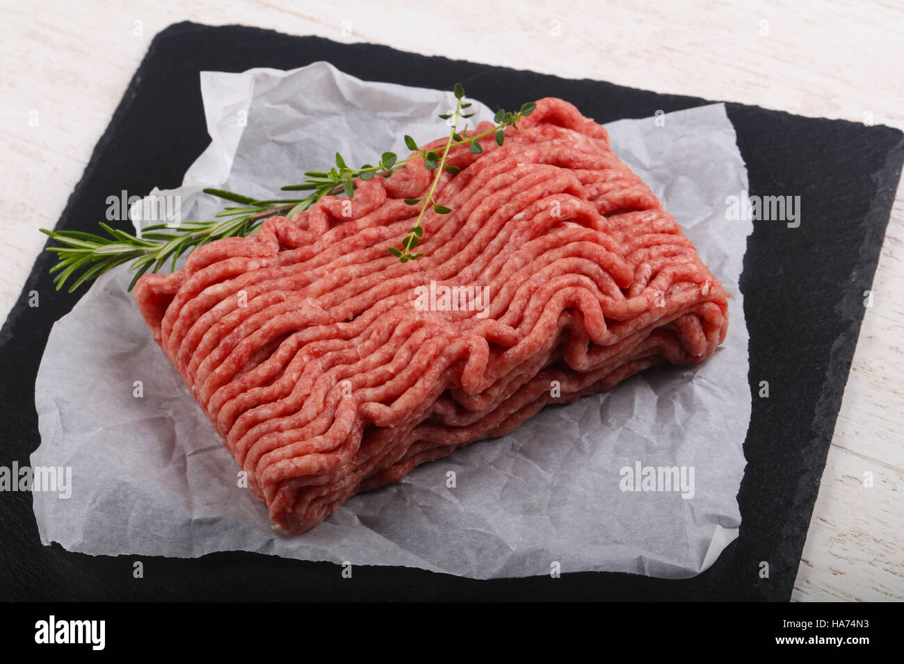 Raw Minced meat with thyme and rosemary Stock Photo - Alamy