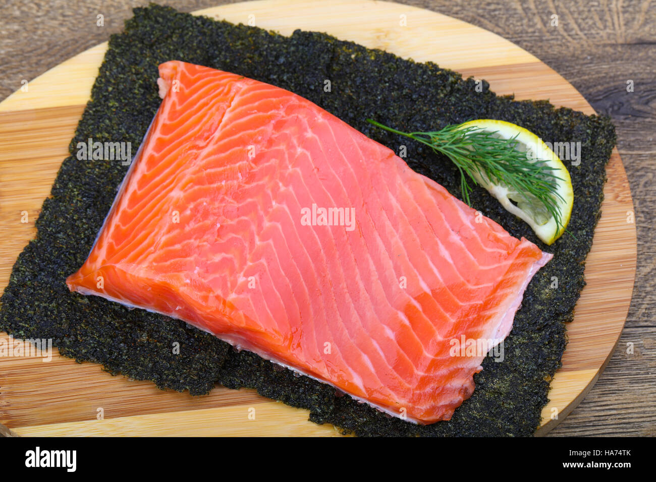 Salmon fillet on nori background with dill and lemon Stock Photo - Alamy