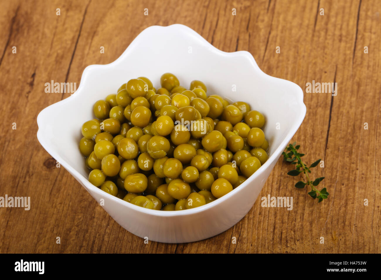 Pickled pea in the plate over wooden background Stock Photo - Alamy