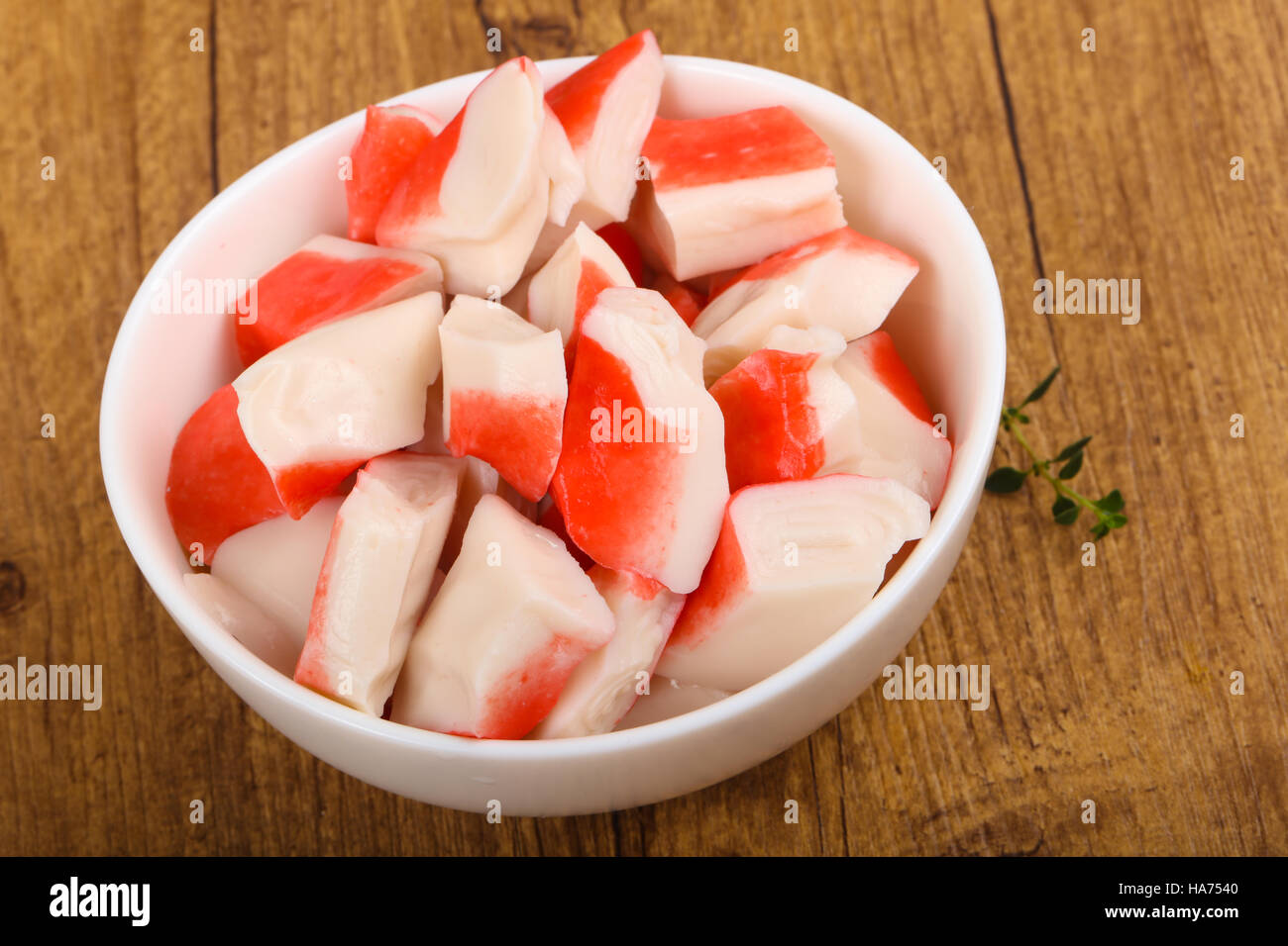Crab stick - surimi in the plate - over wood background Stock Photo - Alamy