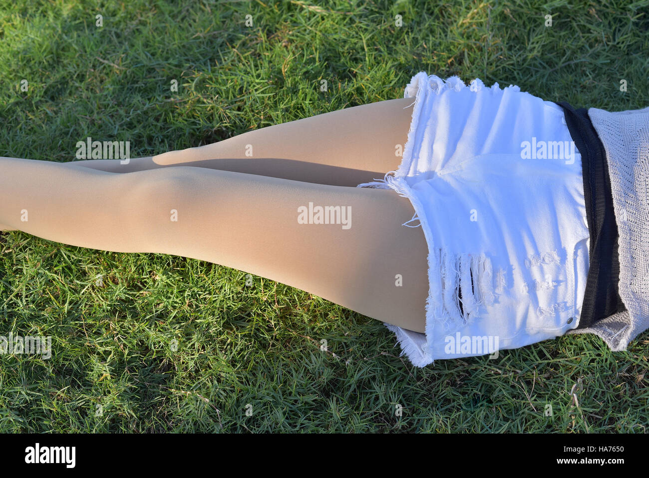 Hop and legs in jeans and leging belongs to beautiful girl lay down on ...