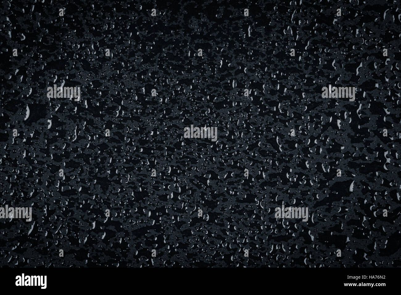 Water drops on dark stone rock surface of basalt or granite Stock Photo ...