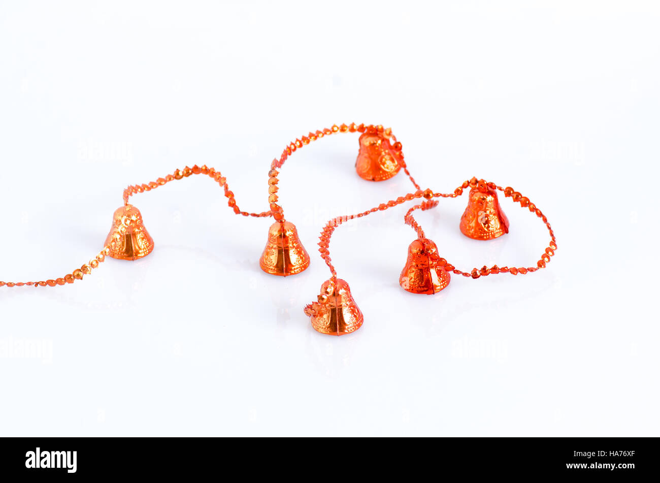 Christmas decoration with red bells on rope isolated on white ...