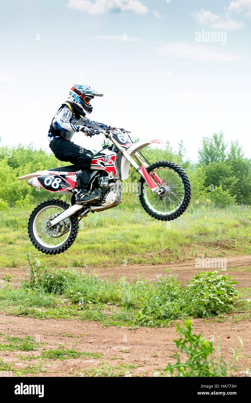 The young sportsman on a motorcycle jump Stock Photo - Alamy