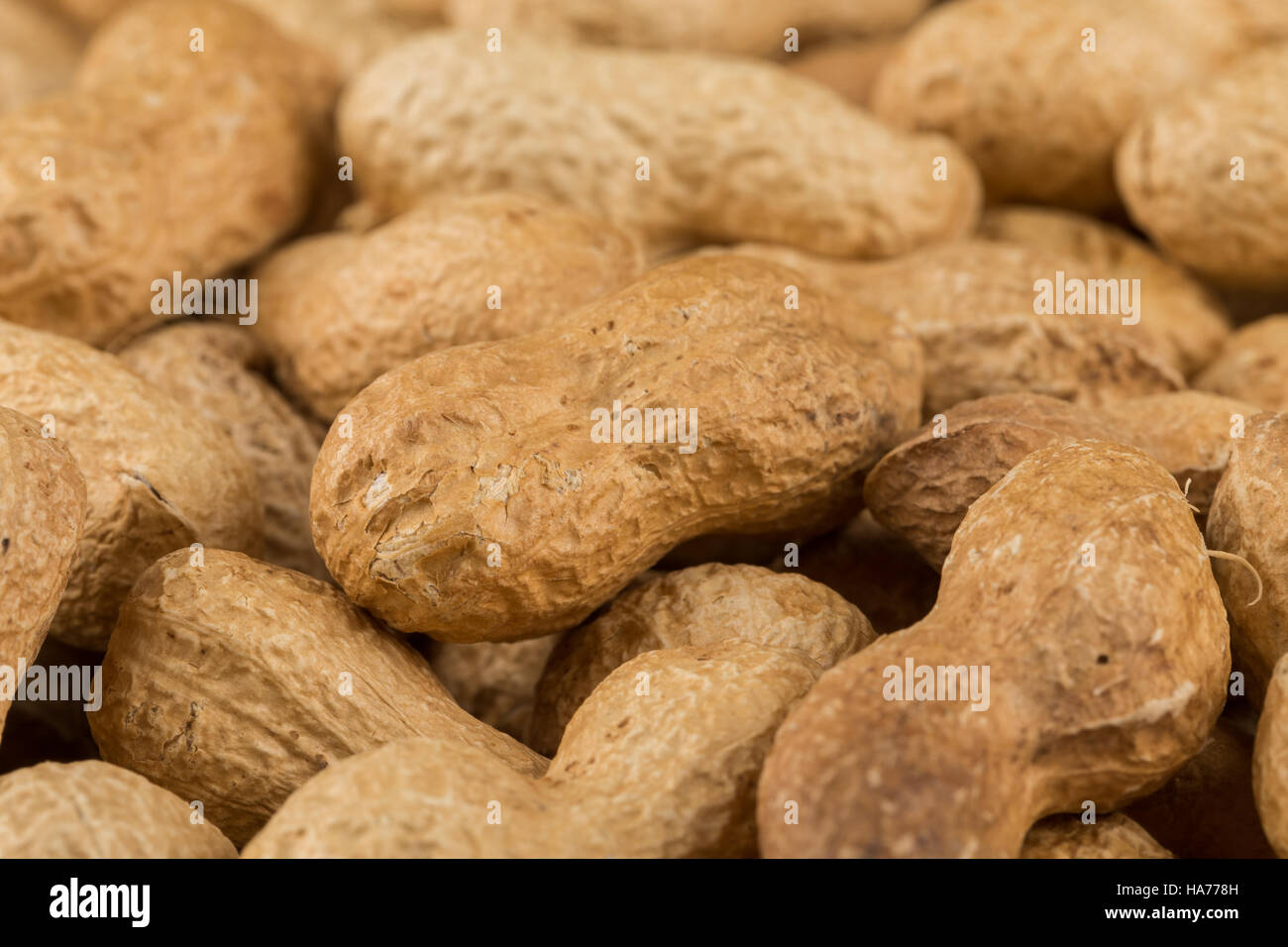 Pile of peanuts shells close up for background Stock Photo - Alamy