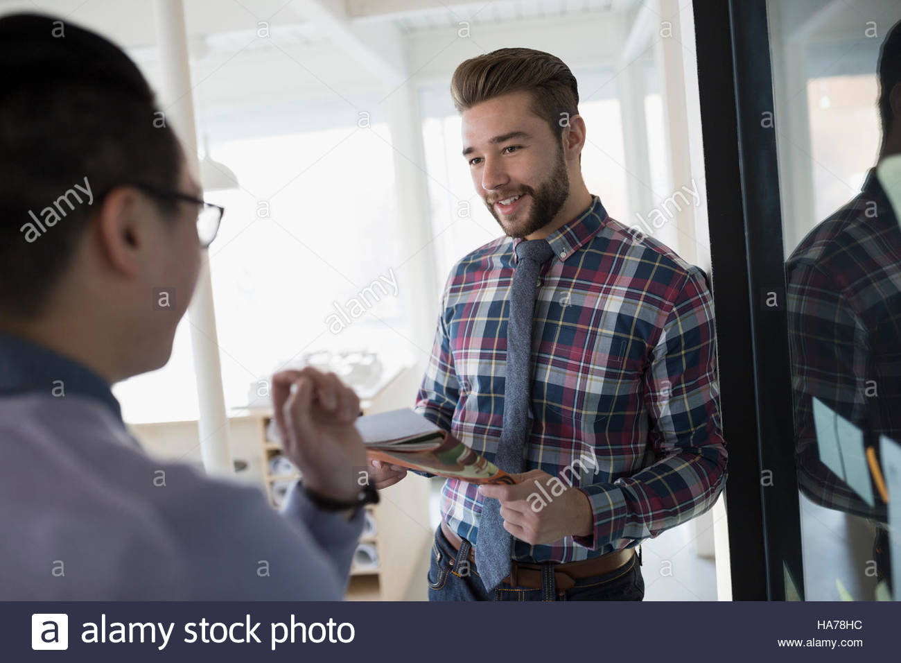 Male architects talking in office Stock Photo - Alamy