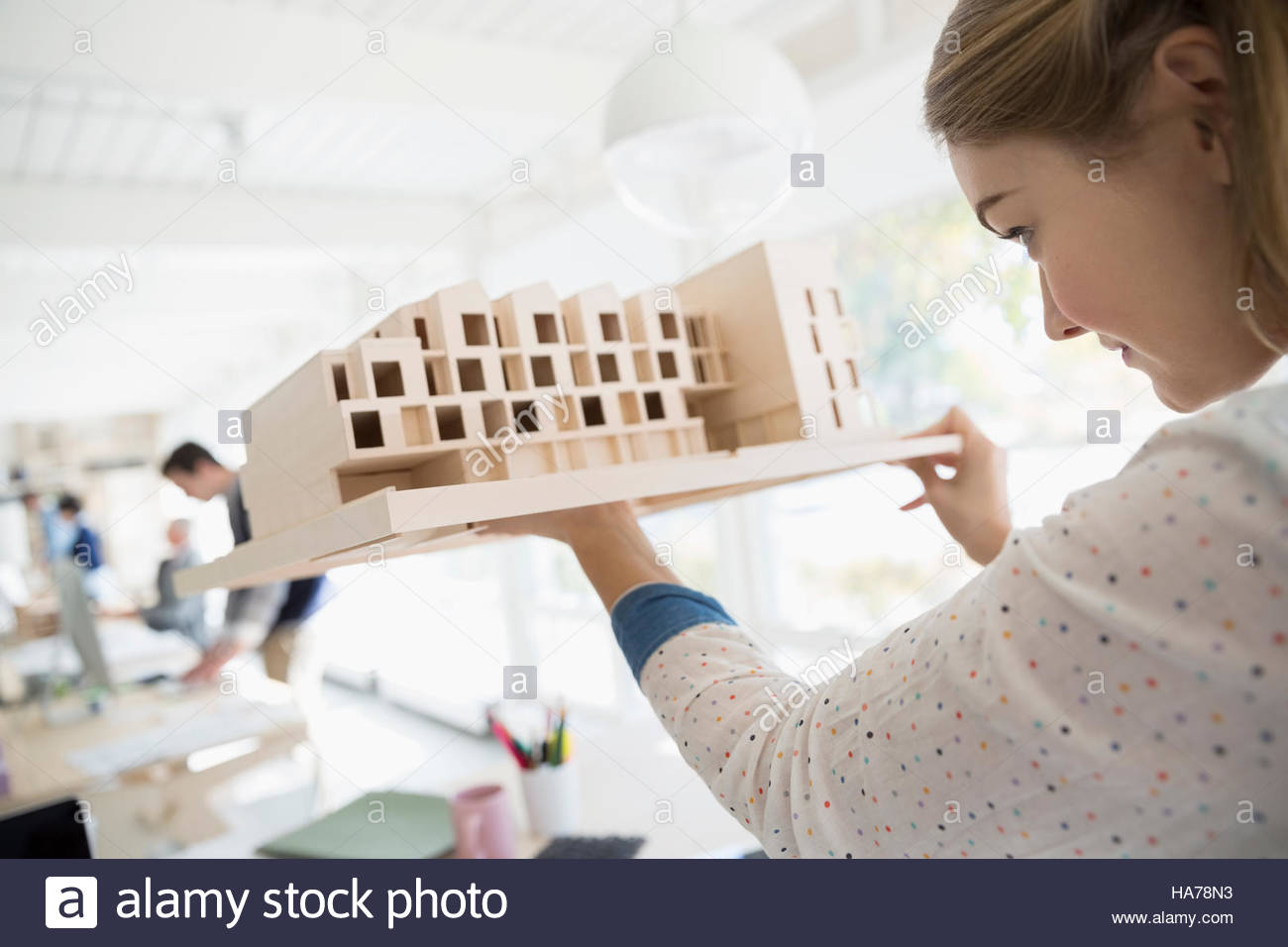 Female architect looking over model hi-res stock photography and images ...