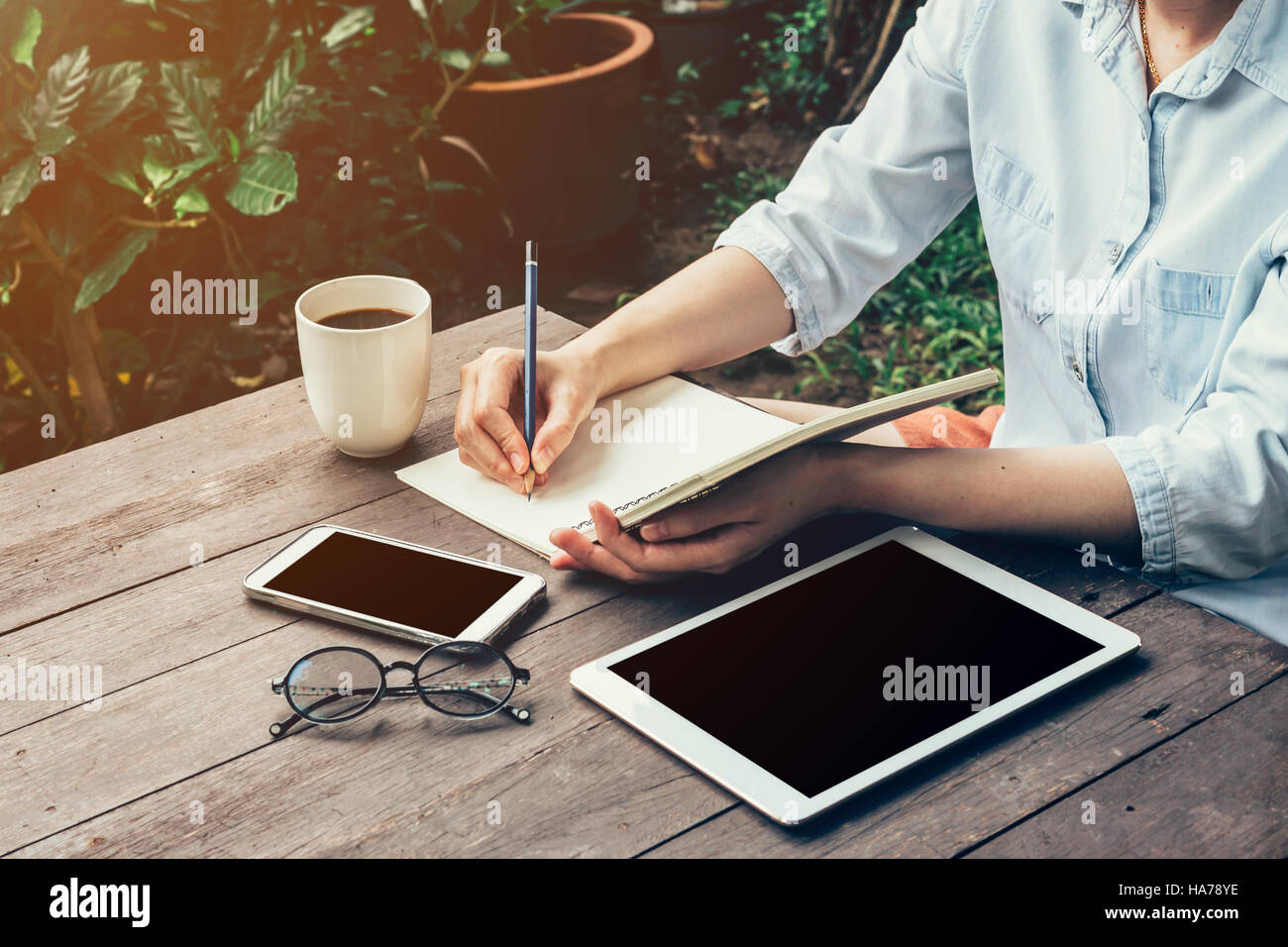 Young business woman hand with pencil writing on notebook. Woman hand ...