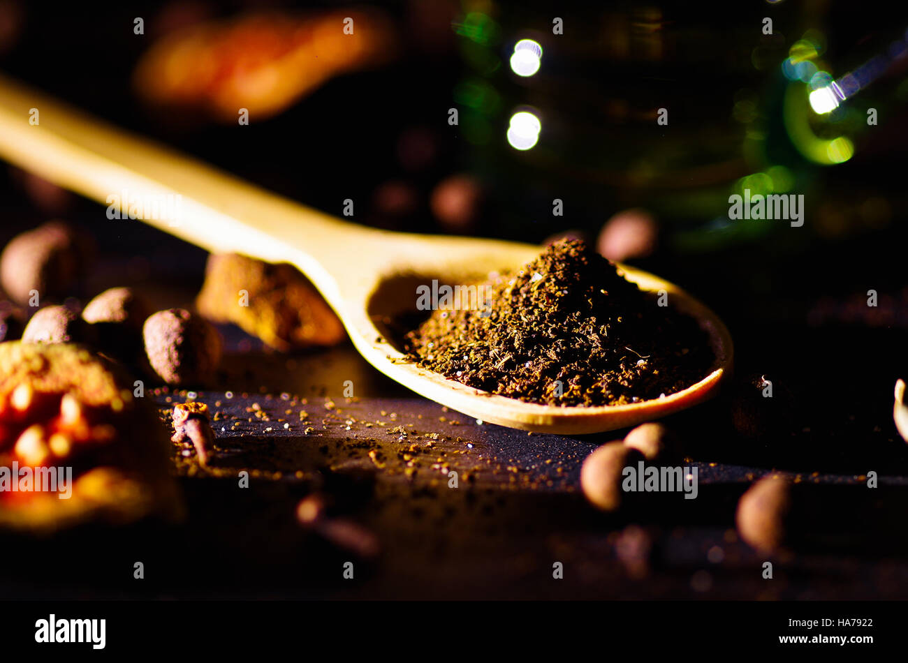 Closeup wooden rustic spoon filled up with fresh herbal tea powder ...