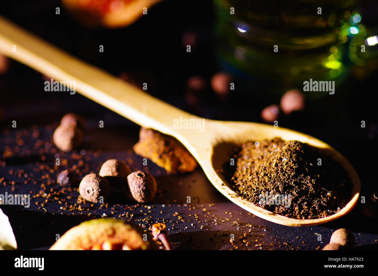 Closeup wooden rustic spoon filled up with fresh herbal tea powder ...