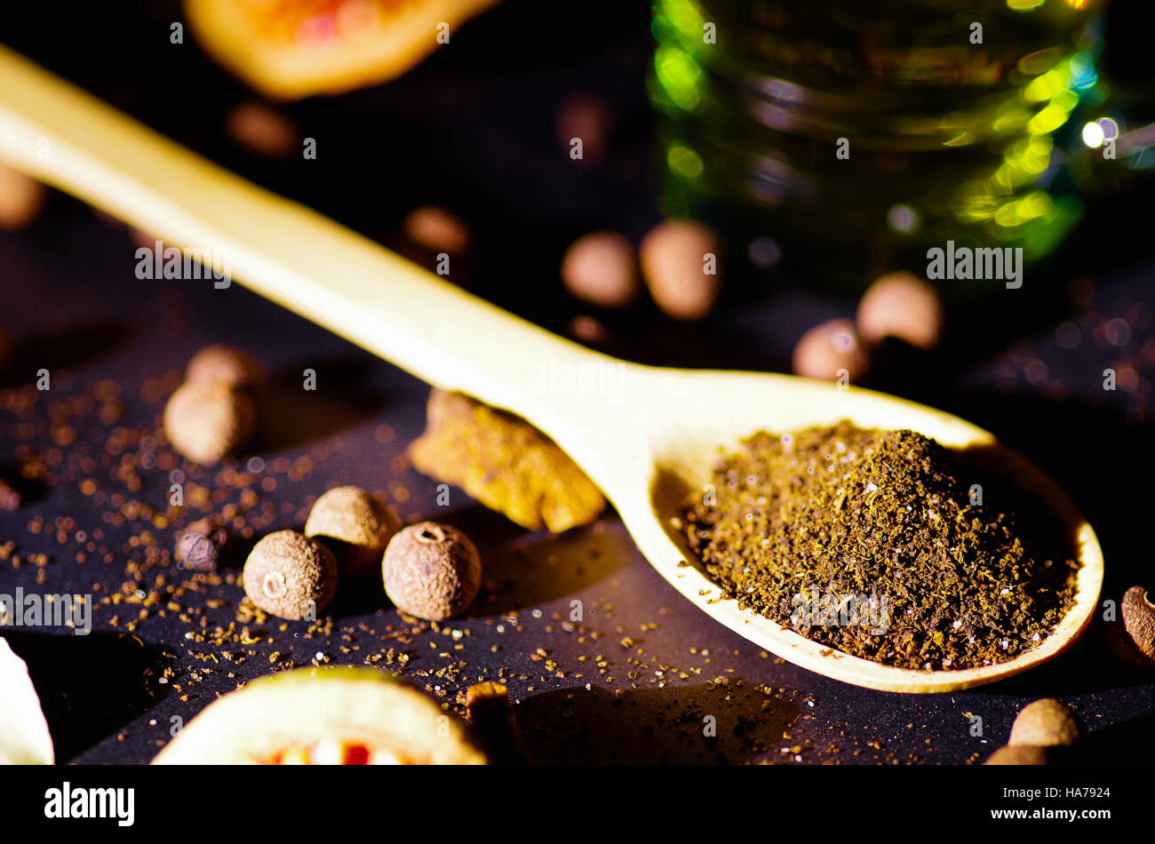 Closeup wooden rustic spoon filled up with fresh herbal tea powder ...