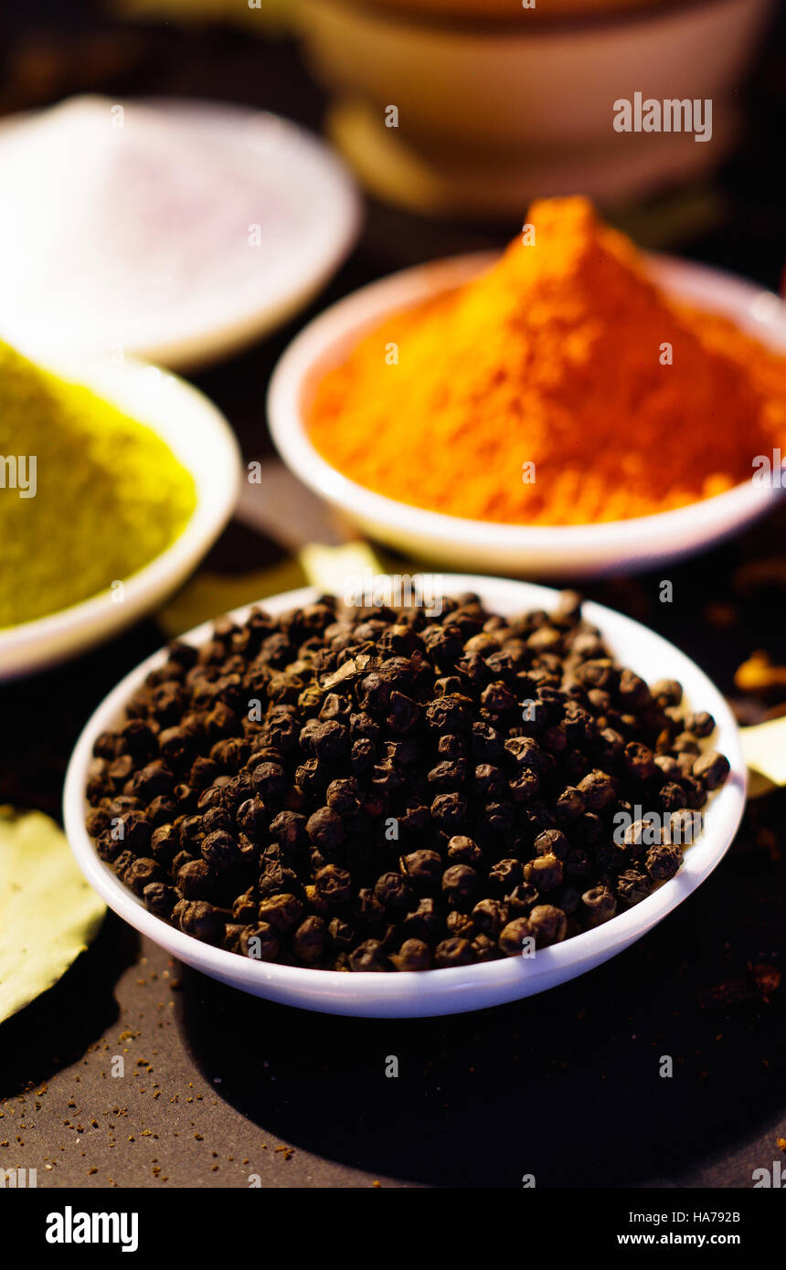 White bowls spread out with different colorful spices inside, beautiful ...