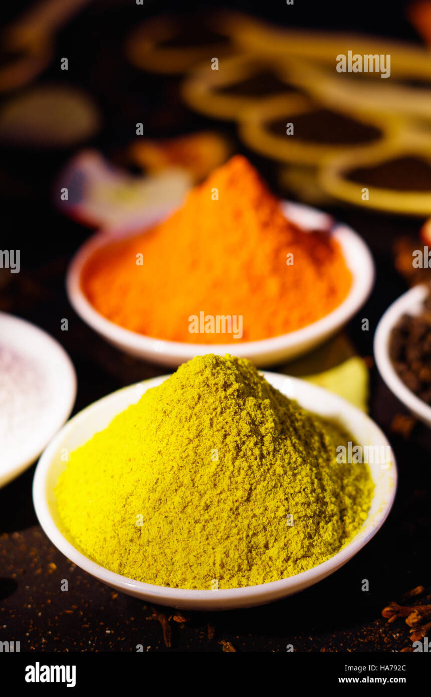 White bowls spread out with different colorful spices inside, beautiful ...