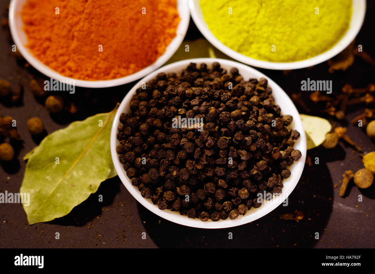 White bowls spread out with different colorful spices inside, beautiful ...