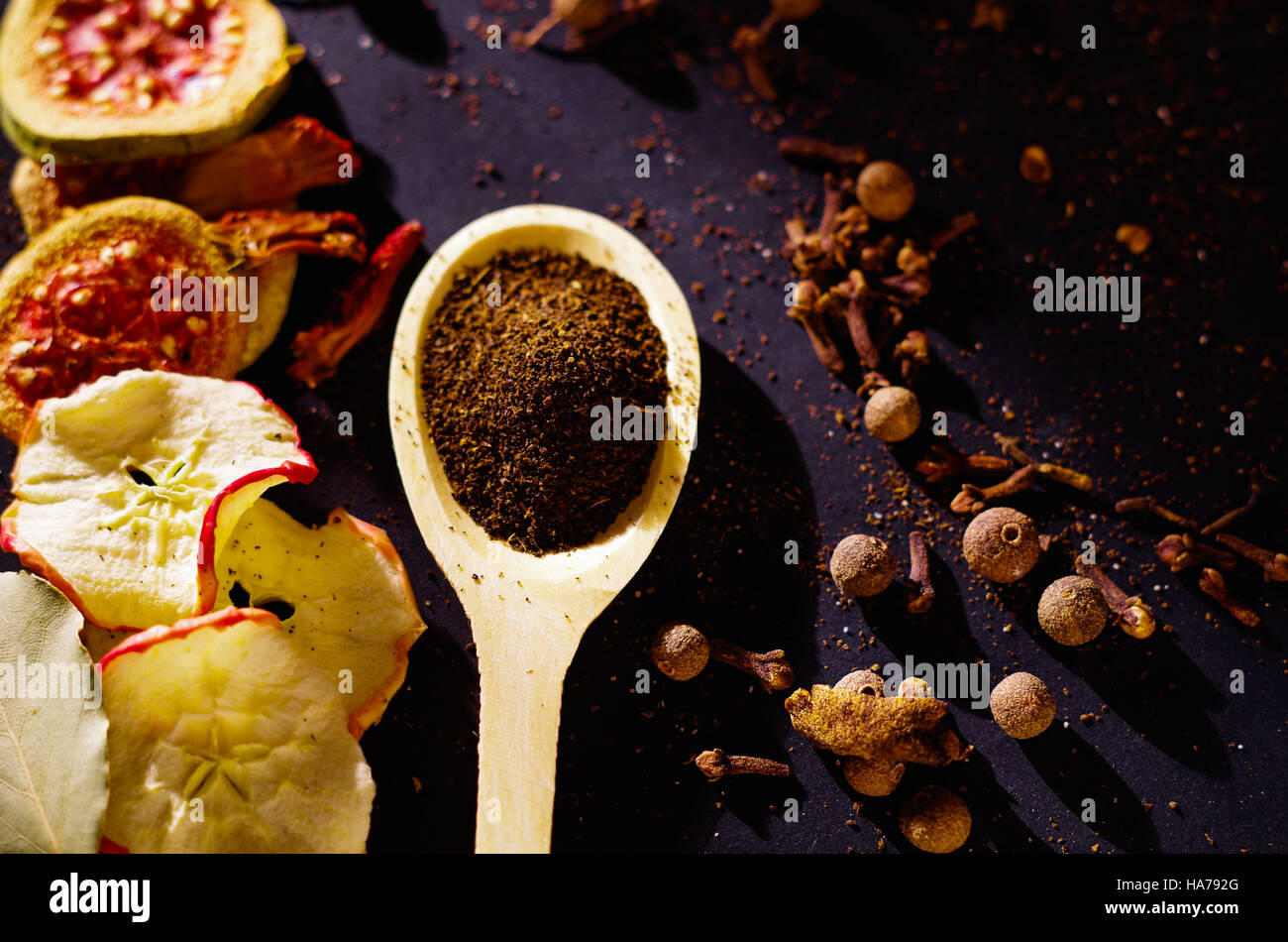 Closeup wooden rustic spoon filled up with fresh herbal tea powder ...
