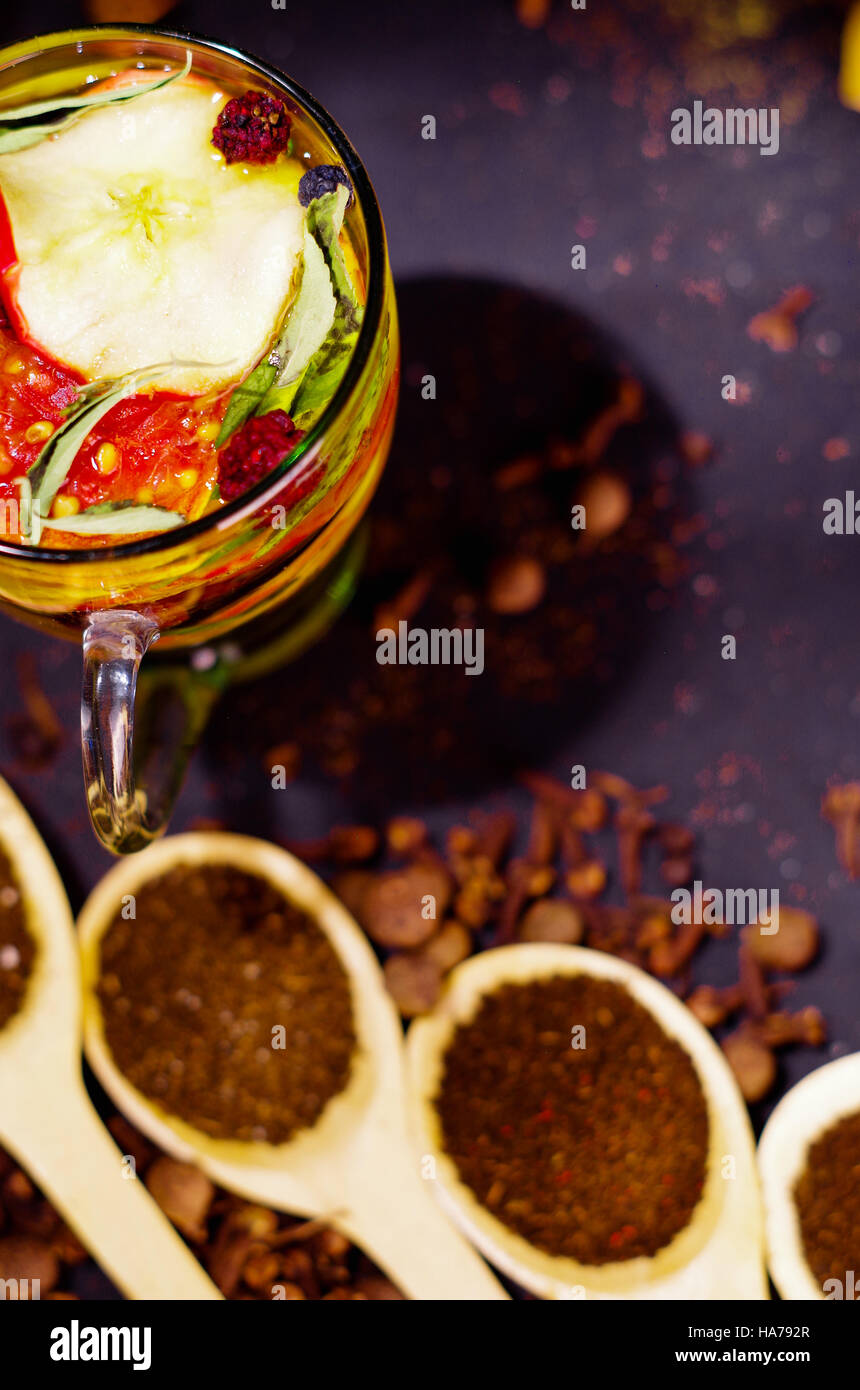 Closeup wooden rustic spoon filled up with fresh herbal tea powder ...