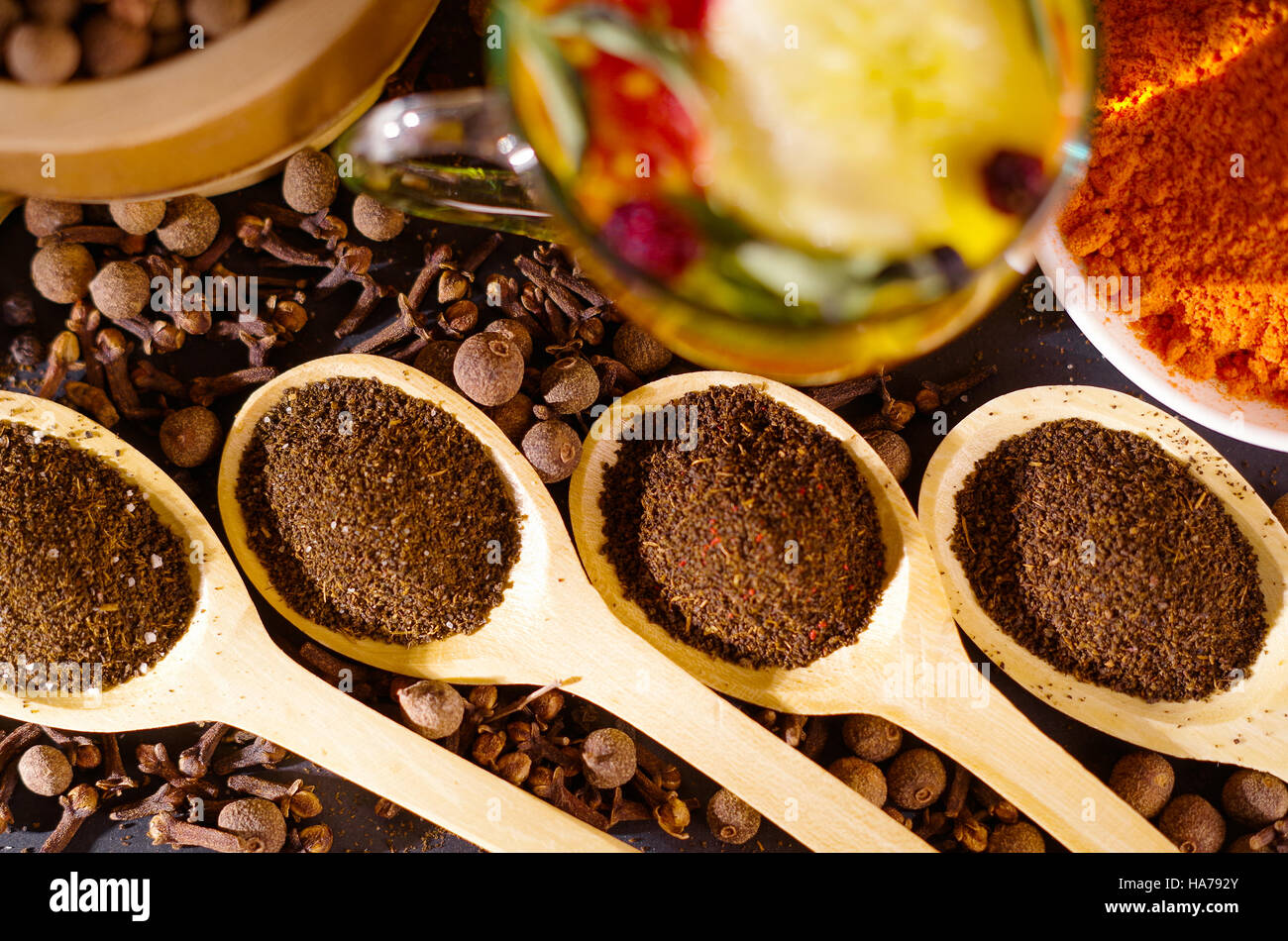 Closeup wooden rustic spoons filled up with fresh herbal tea powder ...