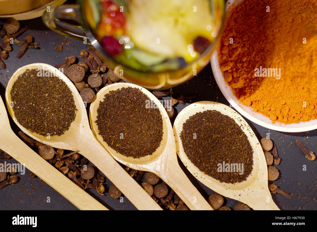 Closeup wooden rustic spoons filled up with fresh herbal tea powder ...
