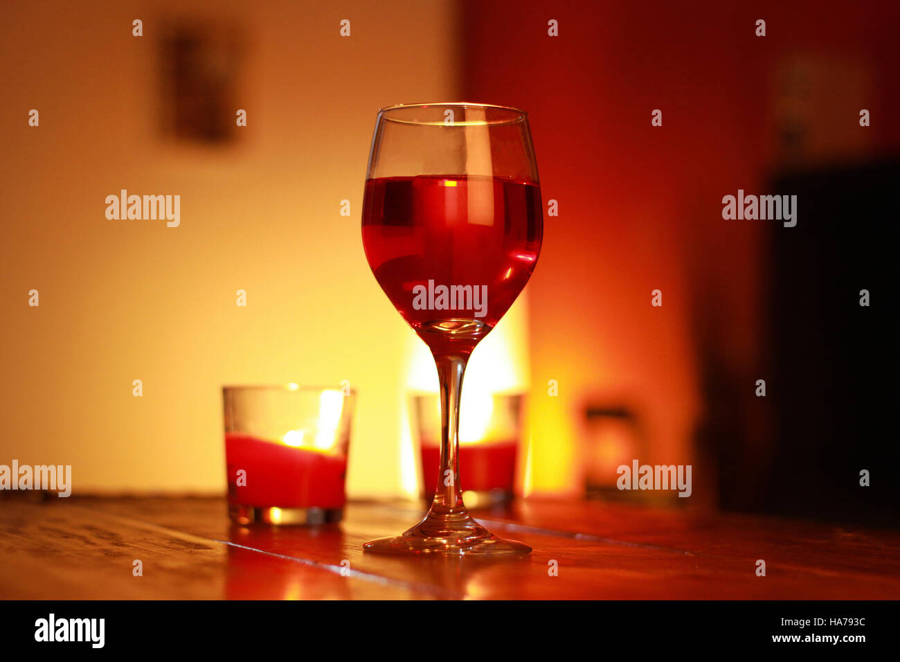 red wine in glass with a living room background and and ambient light ...