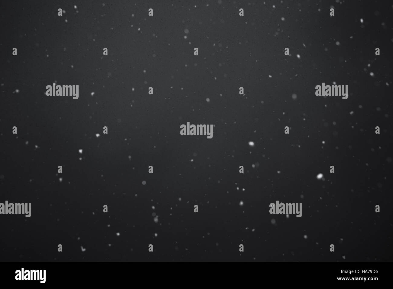 Falling snow on black background Stock Photo - Alamy