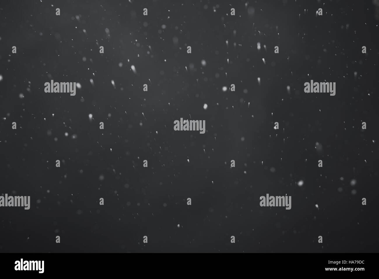 Falling snow on black background Stock Photo - Alamy