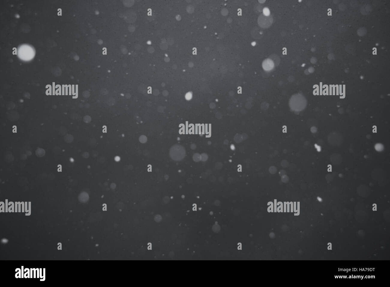 Falling snow on black background Stock Photo - Alamy