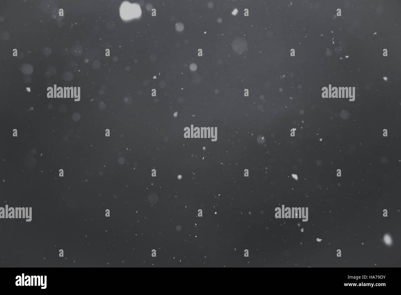 Falling snow on black background Stock Photo - Alamy