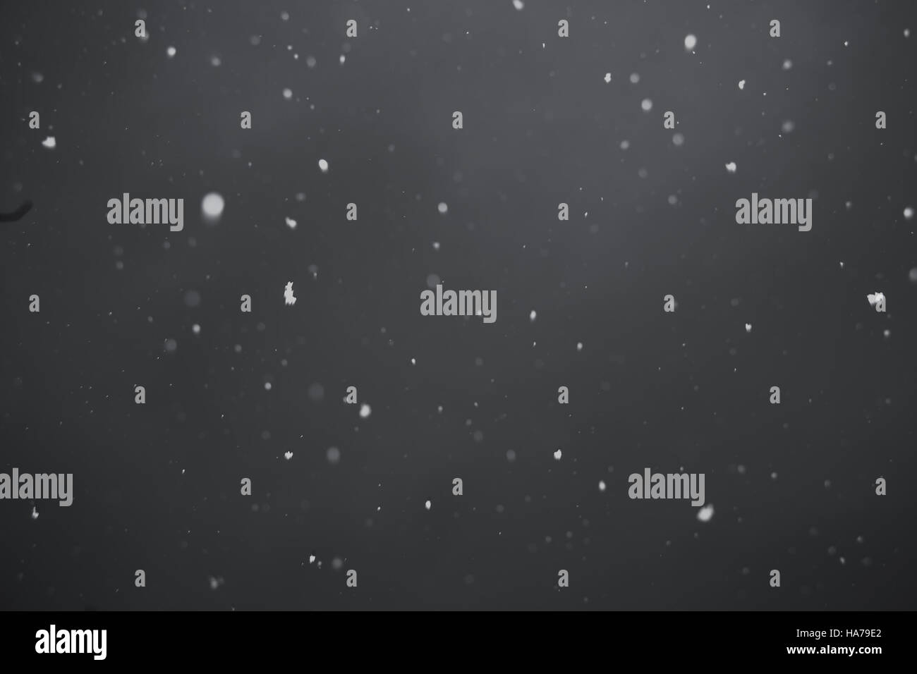 Falling snow on black background Stock Photo - Alamy