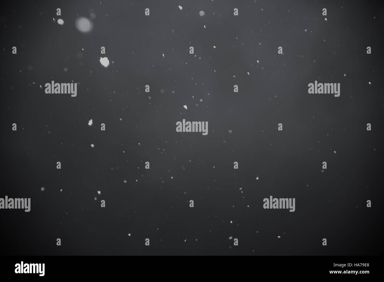 Falling snow on black background Stock Photo - Alamy