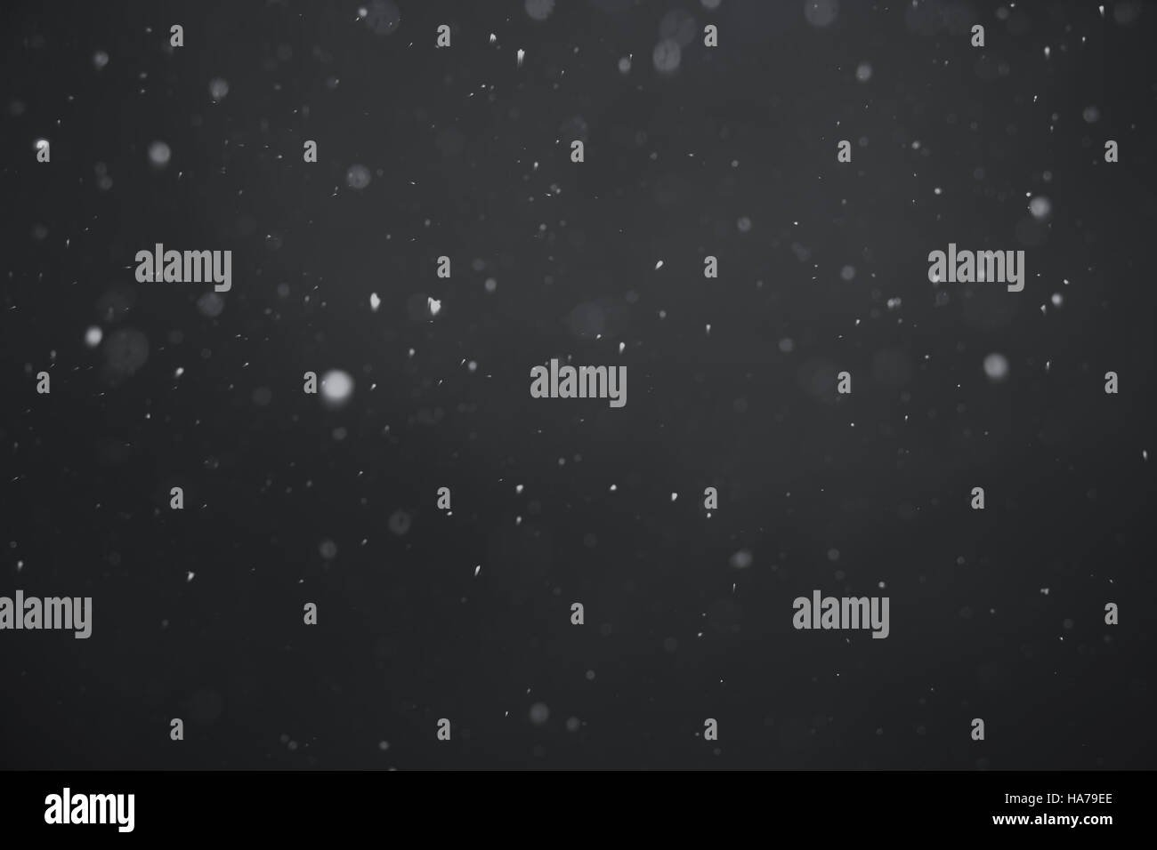 Falling snow on black background Stock Photo - Alamy