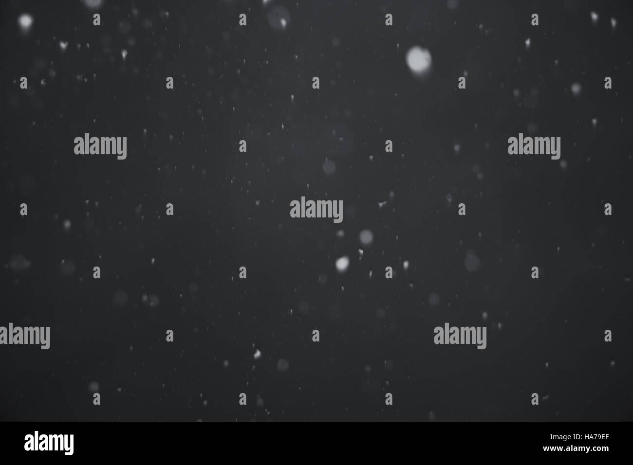 Falling snow on black background Stock Photo - Alamy