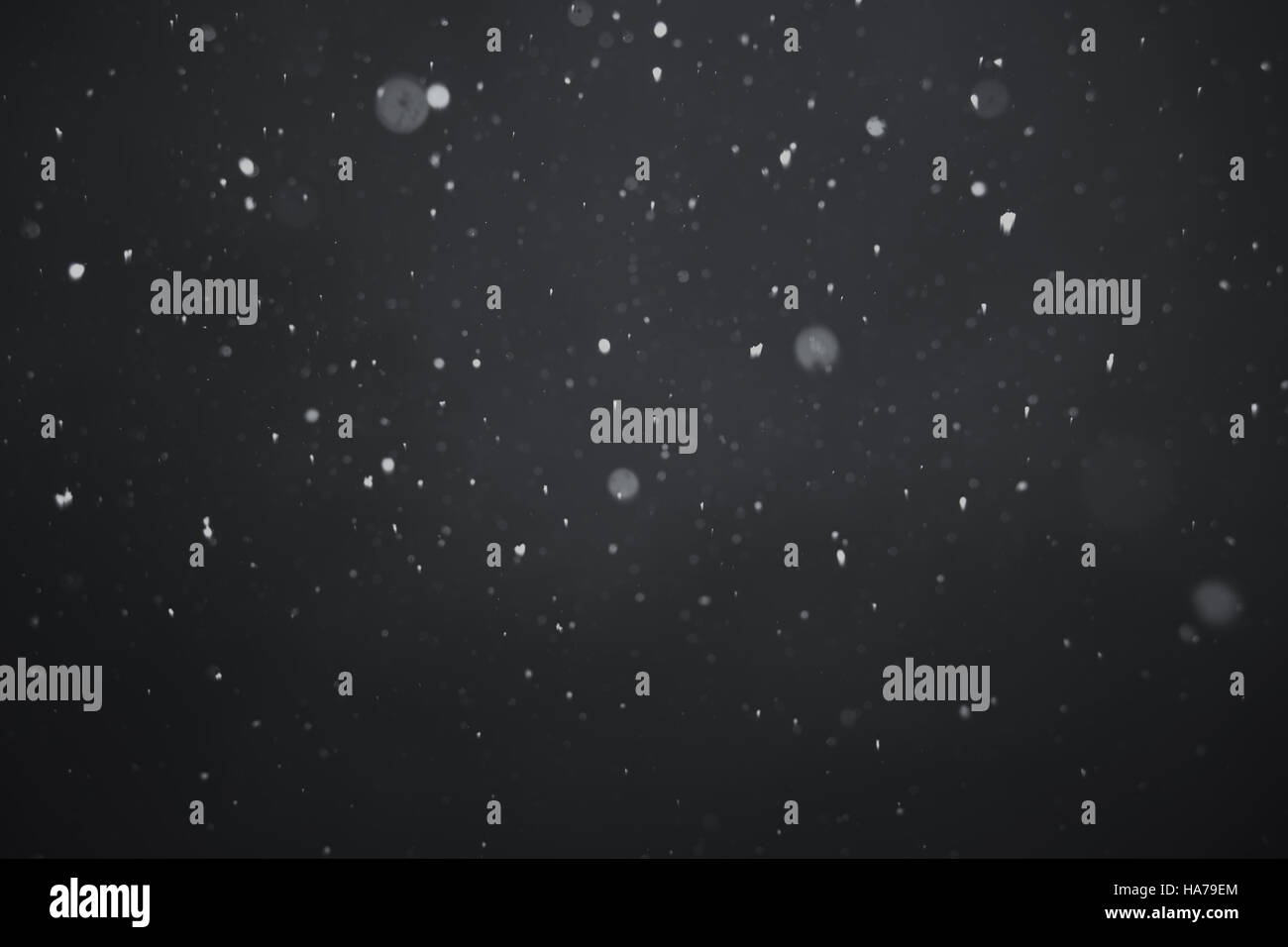 Falling snow on black background Stock Photo - Alamy