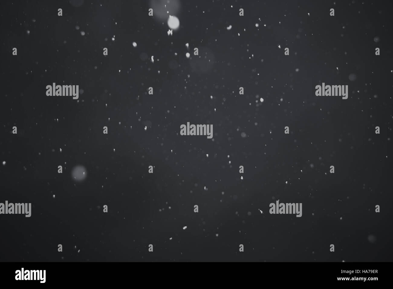Falling snow on black background Stock Photo - Alamy